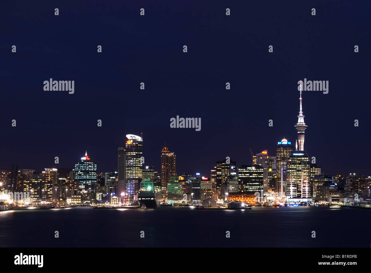 Auckland city skyline at night with the illuminated Skytower dominating ...