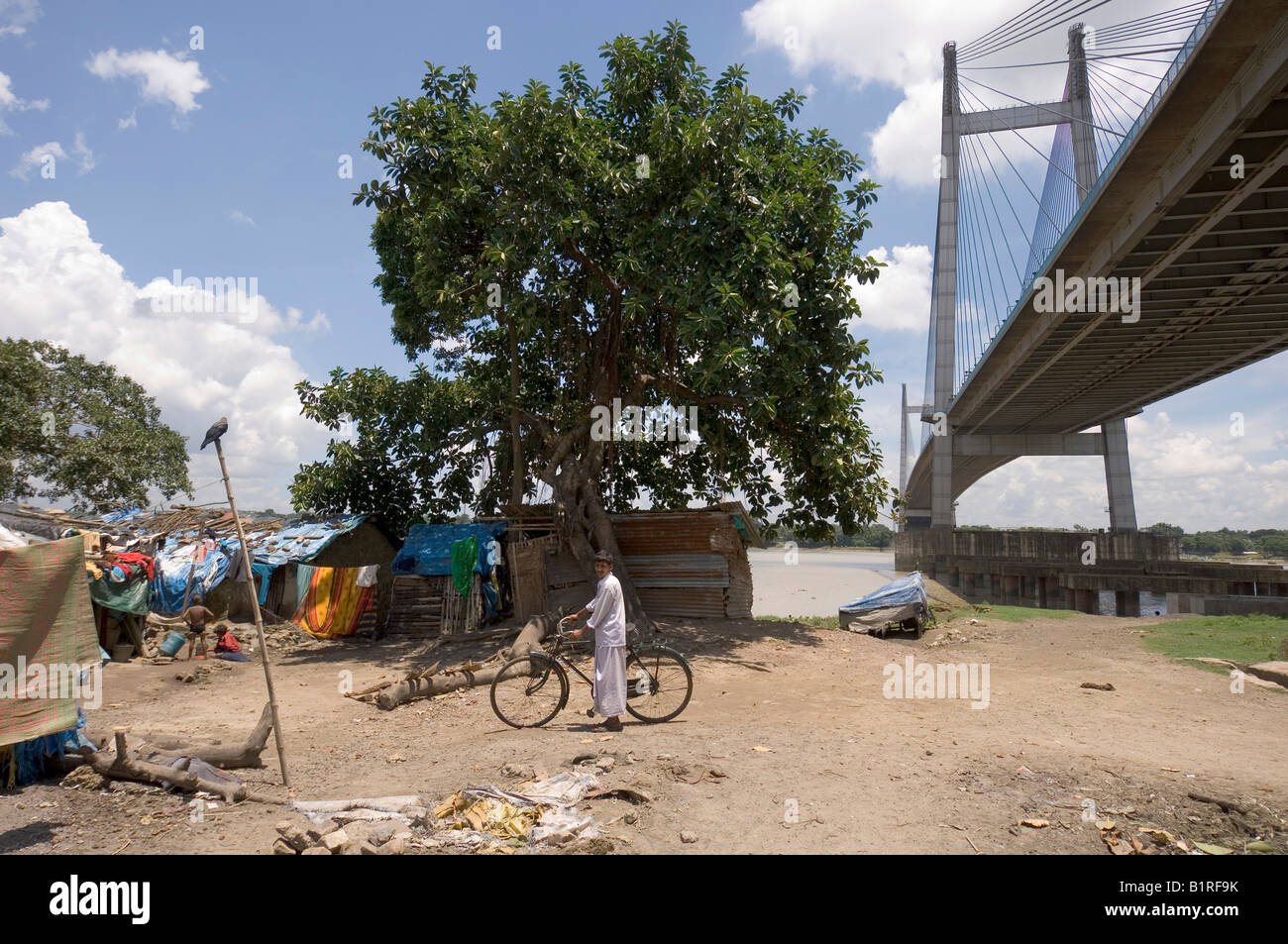 Typical slum under the Second Howrah Bridge along the bank of the ...