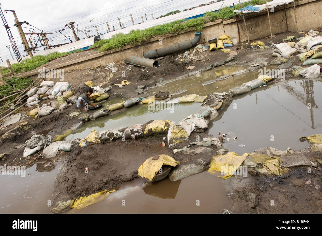 Indian day labourer using sorting copper splinters from toxic ...