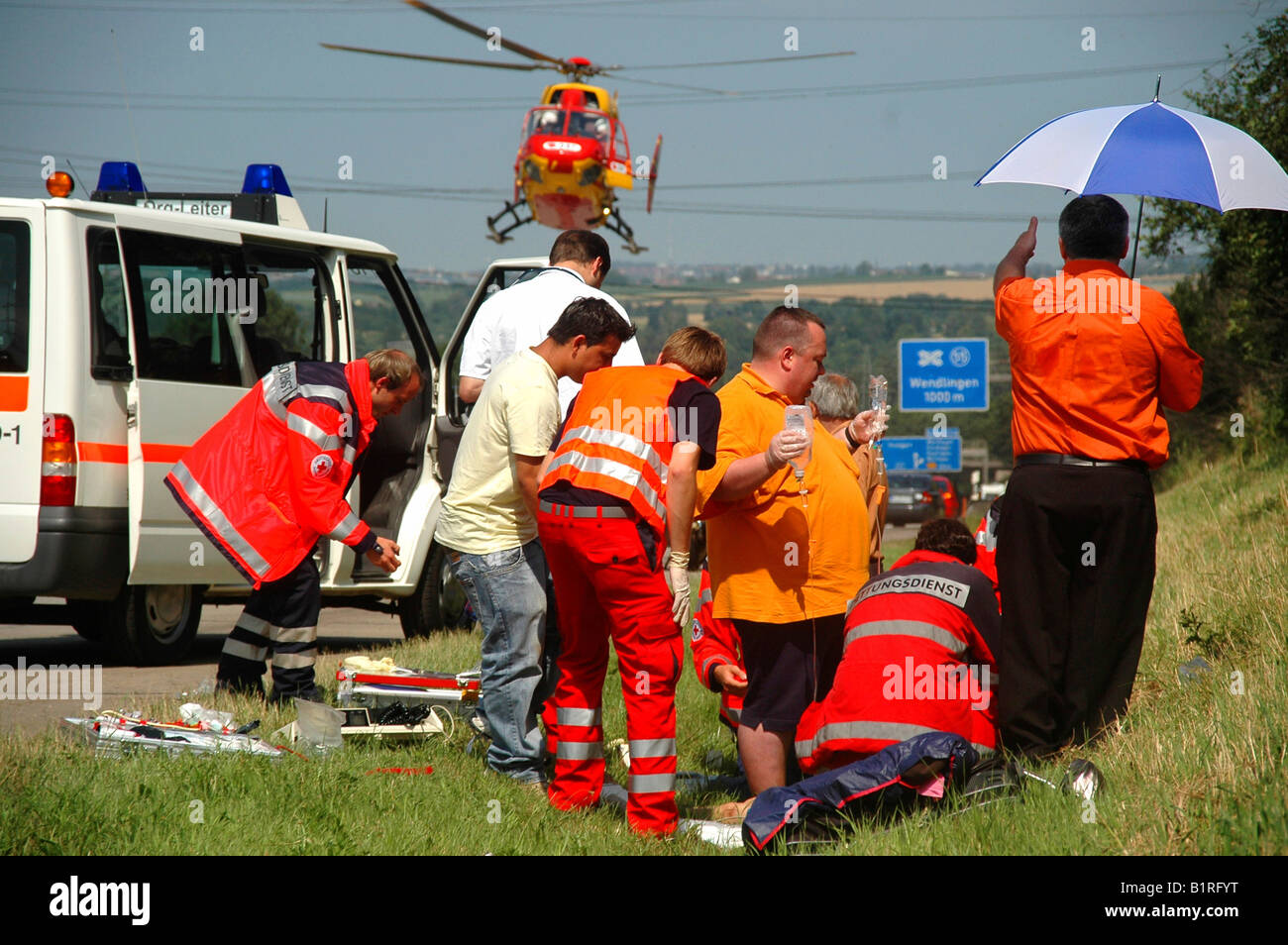 Paramedics and rescue workers of the German Red Cross or DRK assisting ...