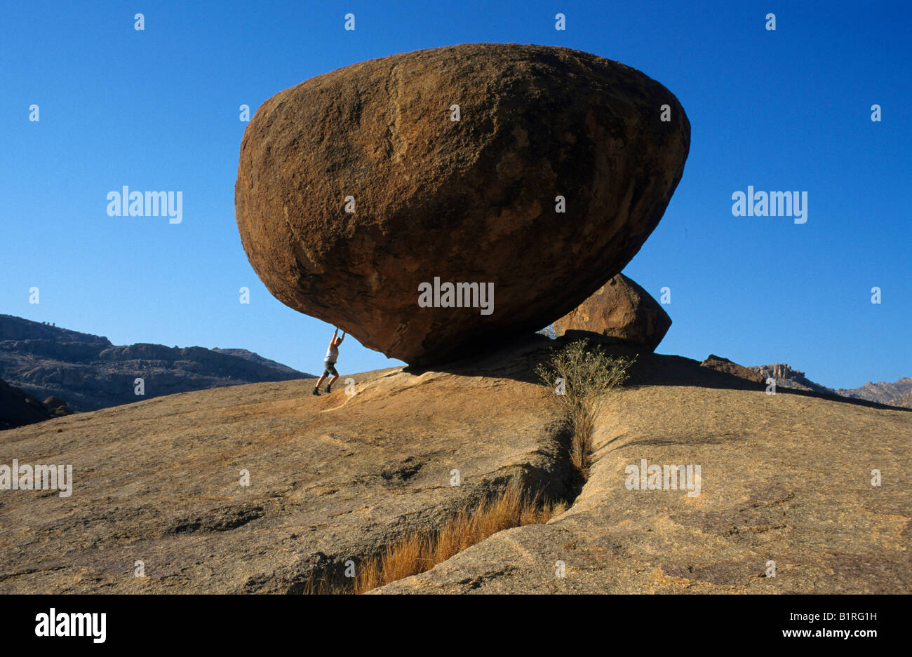 Woman supporting boulder's weight, Bull's Party, Ameib Ranch, Namibia ...