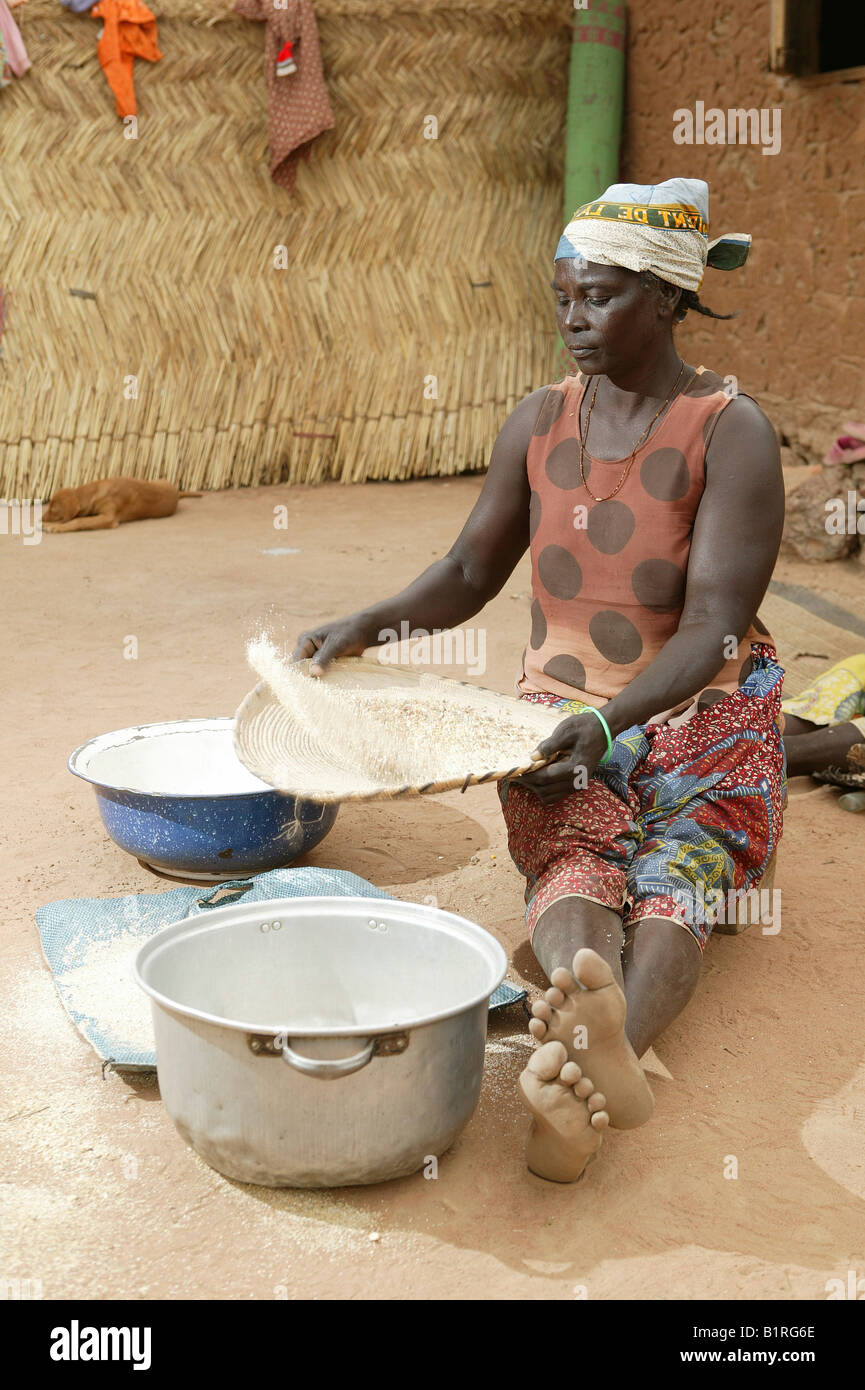 African woman winnowing millet hi-res stock photography and images - Alamy