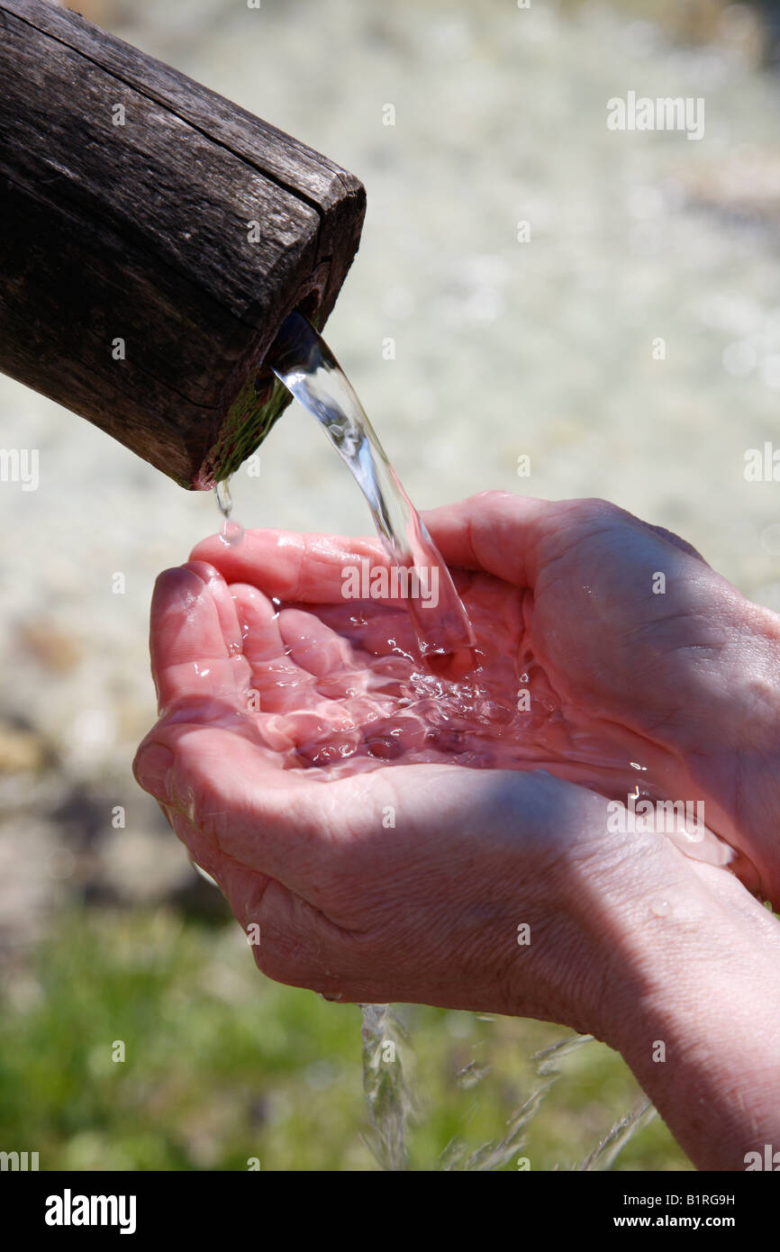 Hands cupping water, spring water from a fountain, Ramsau Church ...
