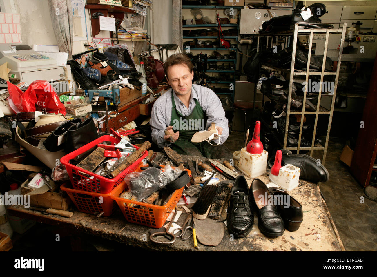 Cobbler, craftsman in an old workshop, Muehldorf am Inn, Upper Bavaria ...