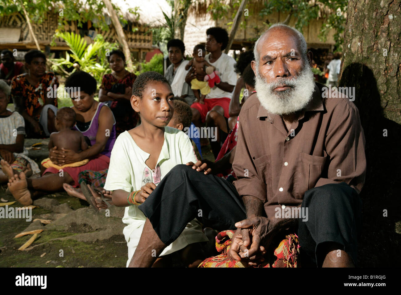 A grandfather and a child during a village community gathering, Mindre ...
