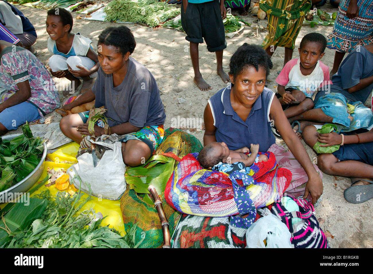 Woman with baby selling handmade Bilum string bags at a market ...