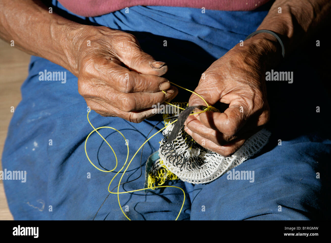 Woman knotting a Bilum string bag, Biliau, Papua New Guinea, Melanesia ...