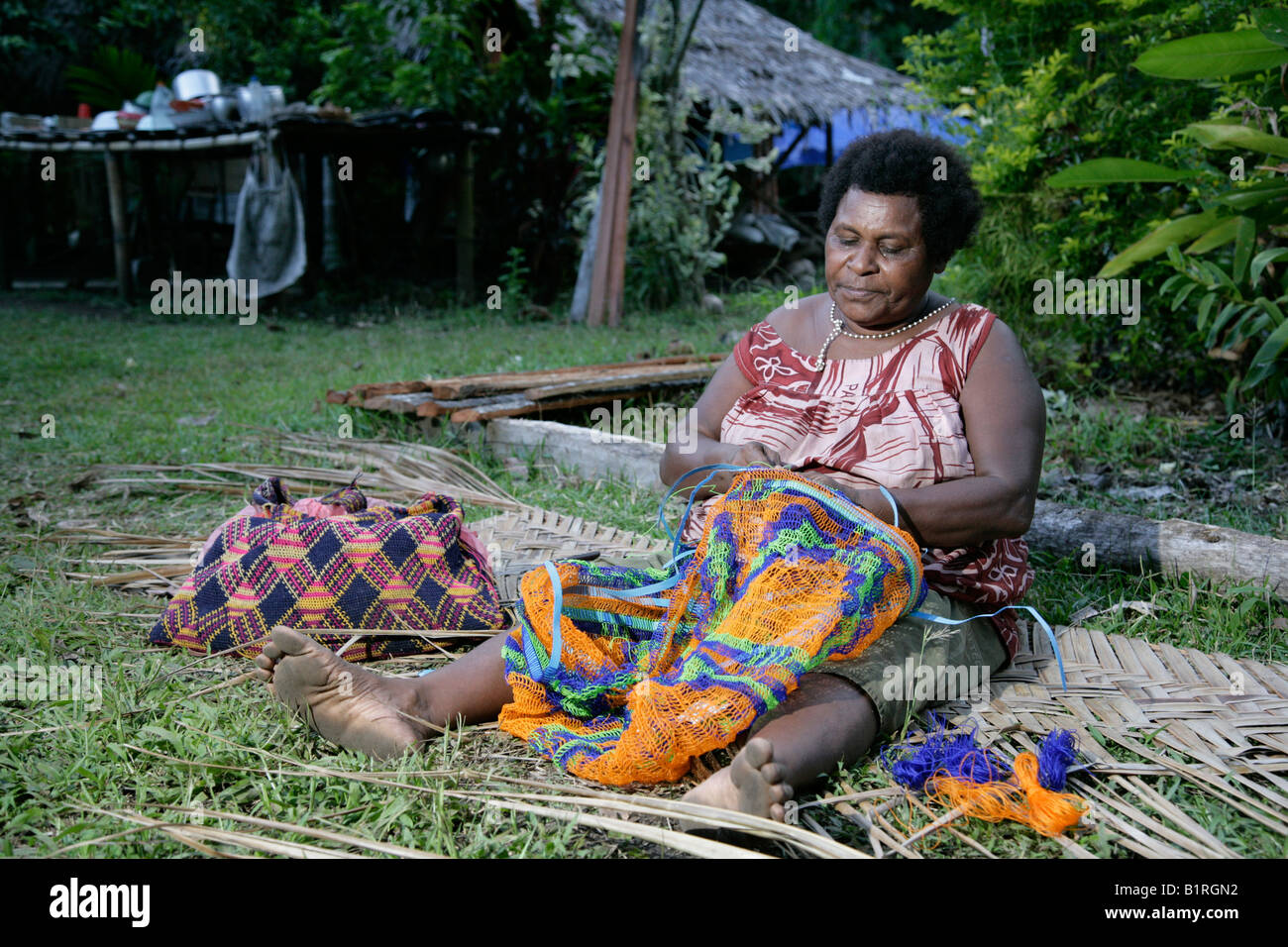 Woman knotting a Bilum string bag, Biliau, Papua New Guinea, Melanesia ...