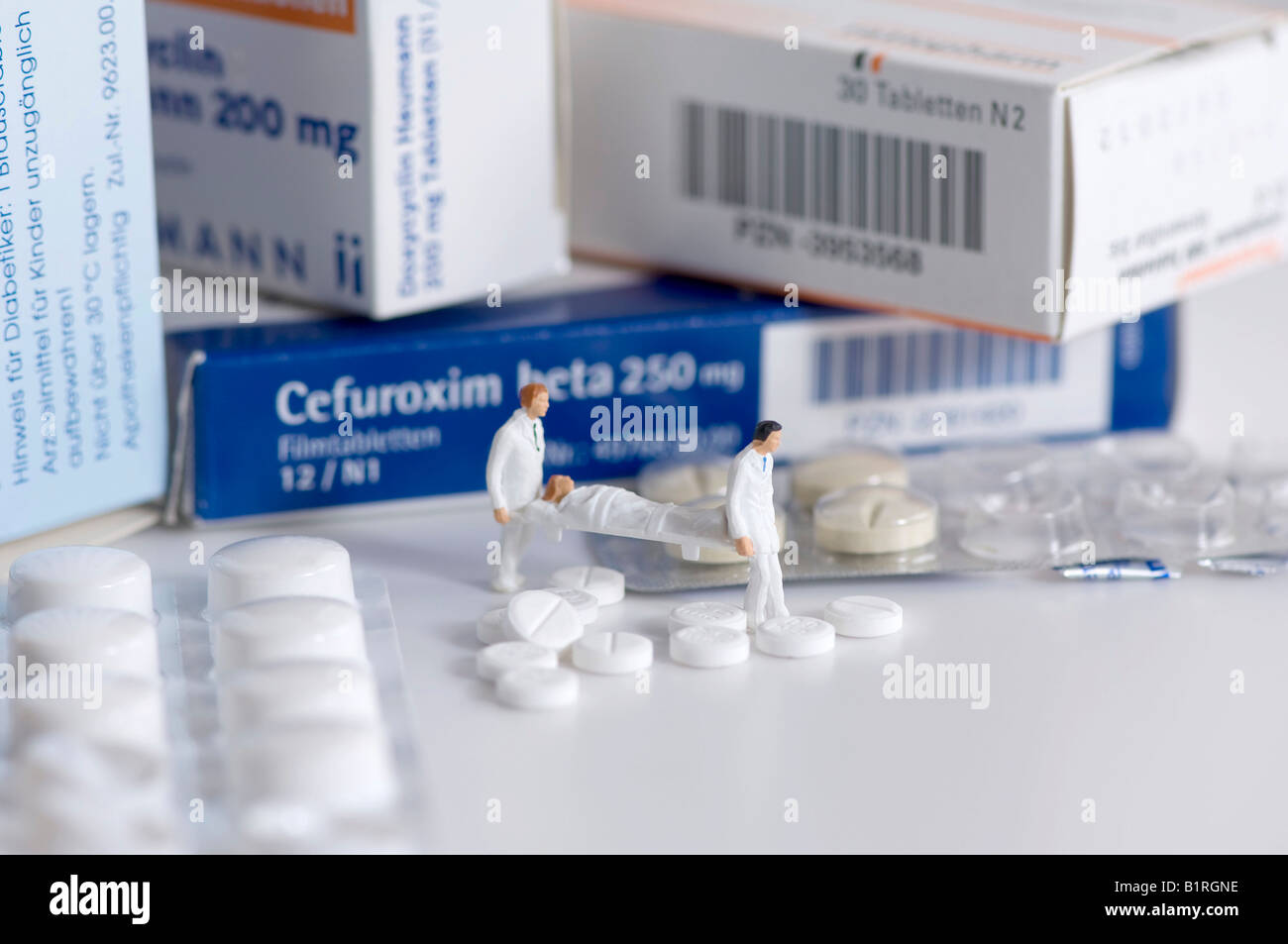 Tablets, blister packs, tablet boxes and miniature paramedics carrying ...