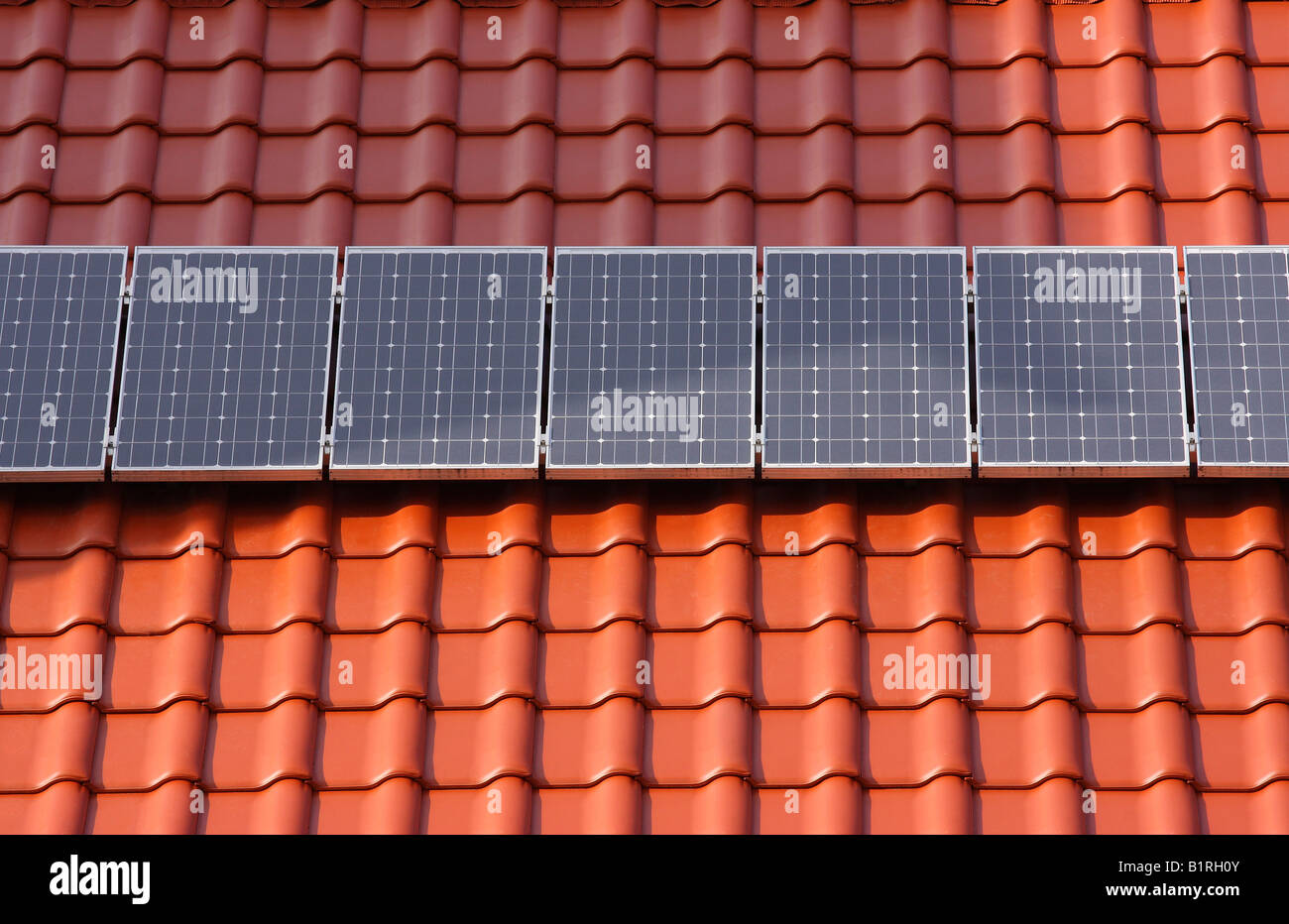 Solar panels on a red tiled roof Stock Photo - Alamy