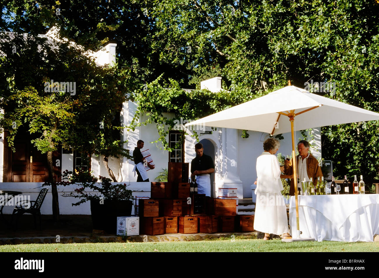 Outdoor wine tasting beneath a shade umbrella at the Blaauwklippen Wine ...