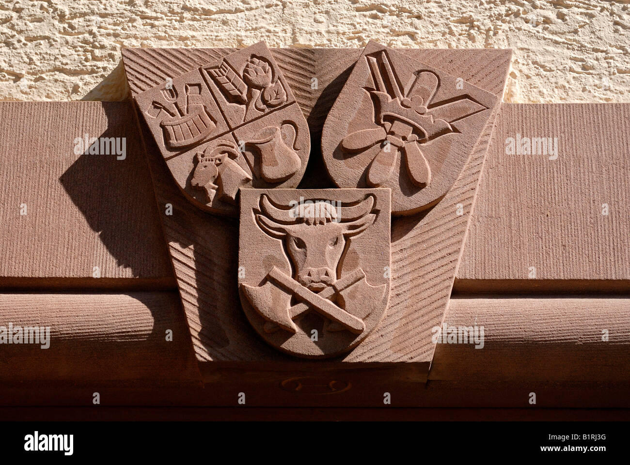 Stonecutter art on wall Stock Photo - Alamy