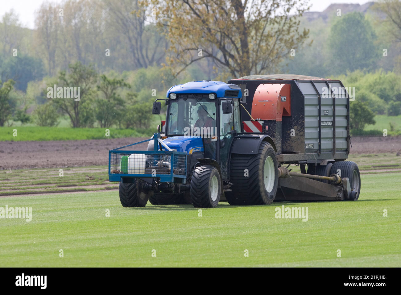 Farmer driving a big tractor on a field, Bergstrasse mountain route ...