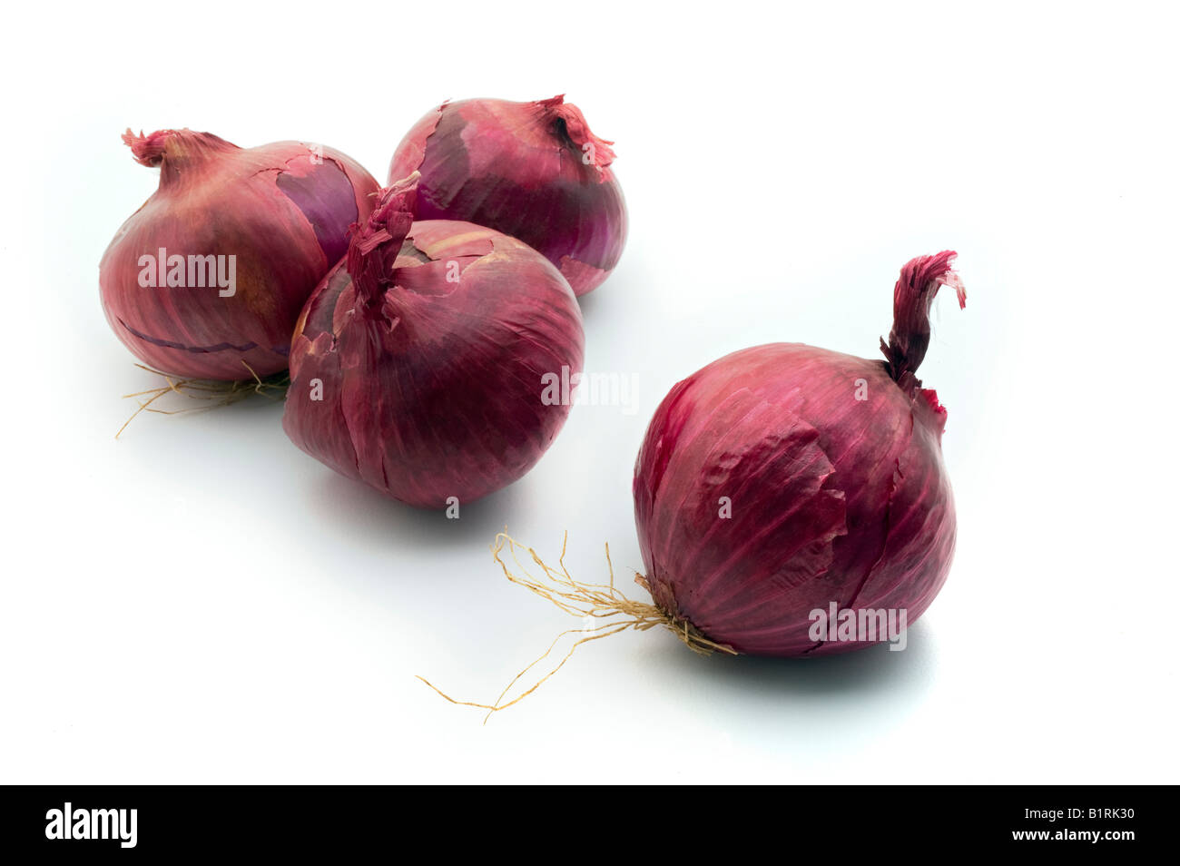 group of purple onions isolated on white background Stock Photo - Alamy