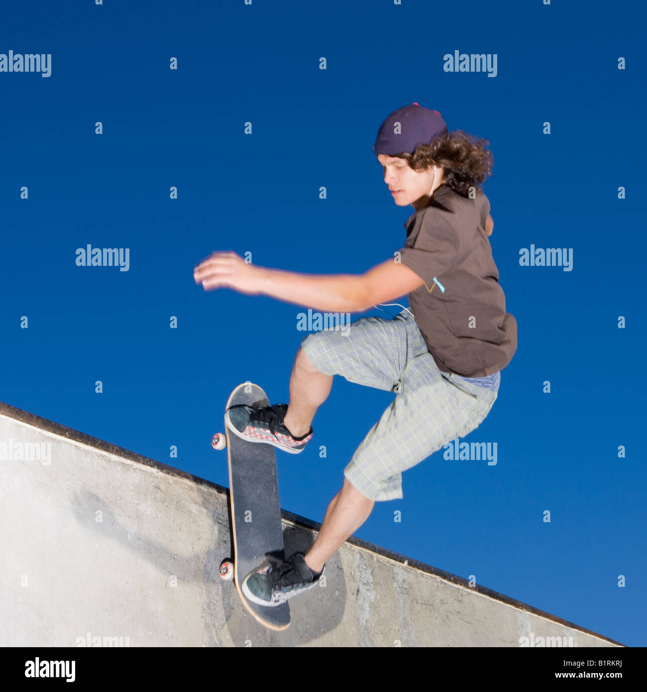 Teen boy does tricks in the half pipe at a skate park Stock Photo - Alamy