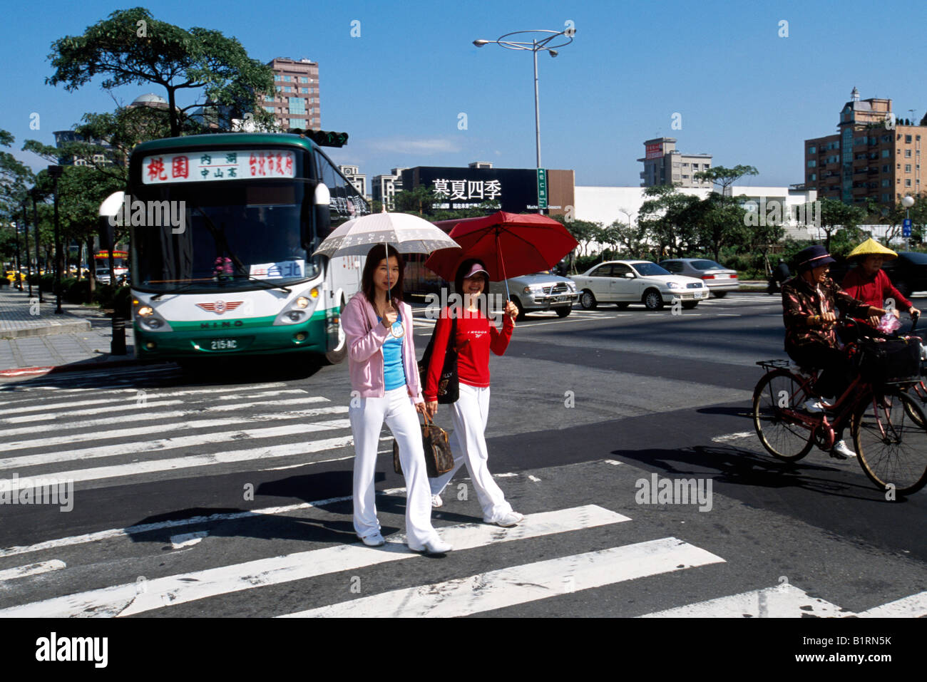 Two taiwanese women on the crosswalk in Taipei City, Taiwan Stock Photo ...