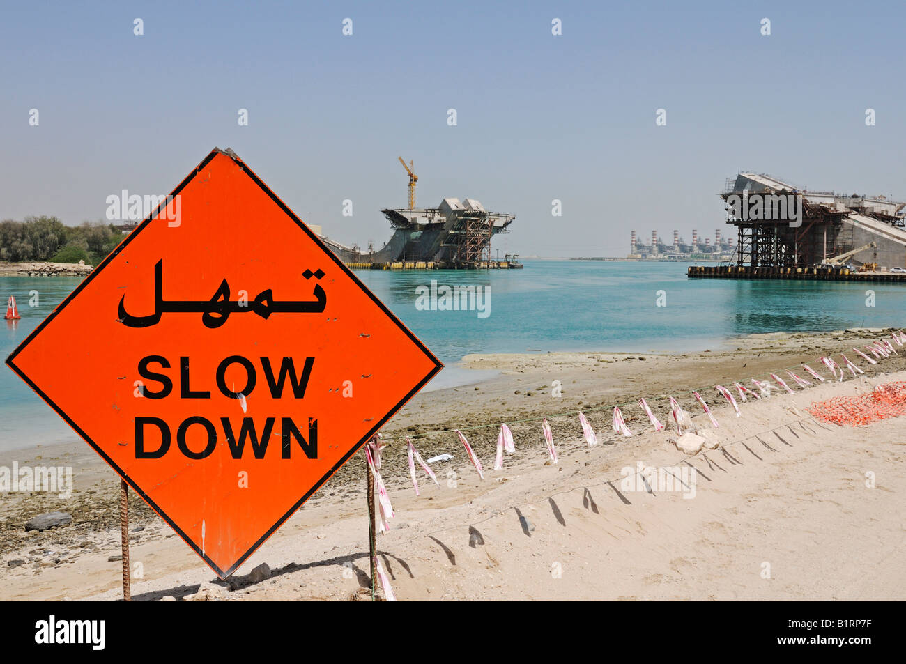 Slow down sign at bridge building site, Abu Dhabi, United Arab Emirates ...