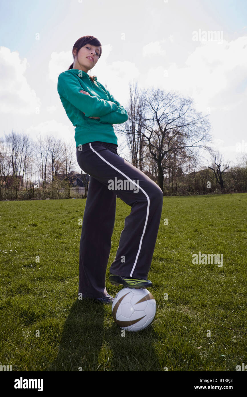 Young woman looking into the camera with her arms crossed and a ...