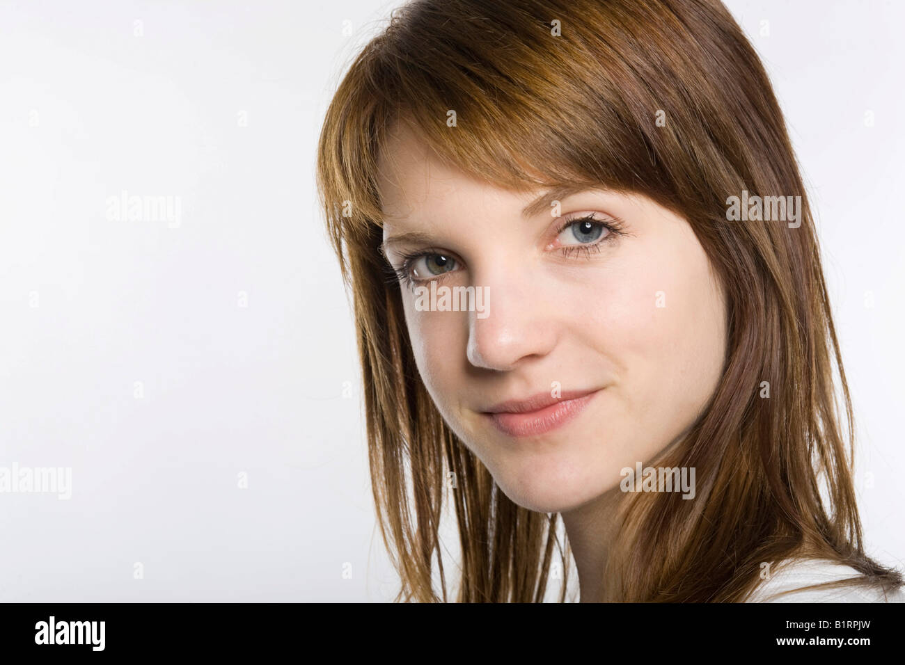 Portrait of young woman, white backdrop Stock Photo - Alamy