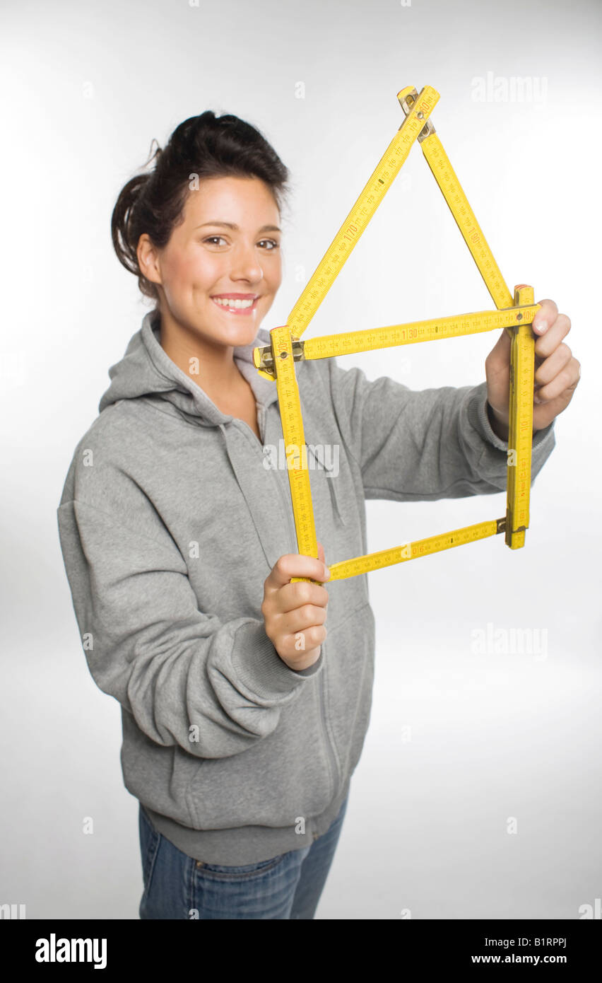 Young woman smiling into the camera holding in her hands a yellow ...