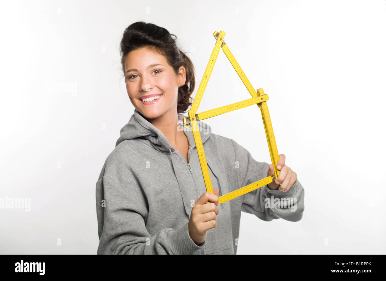 Young woman smiling into the camera holding in her hands a yellow ...