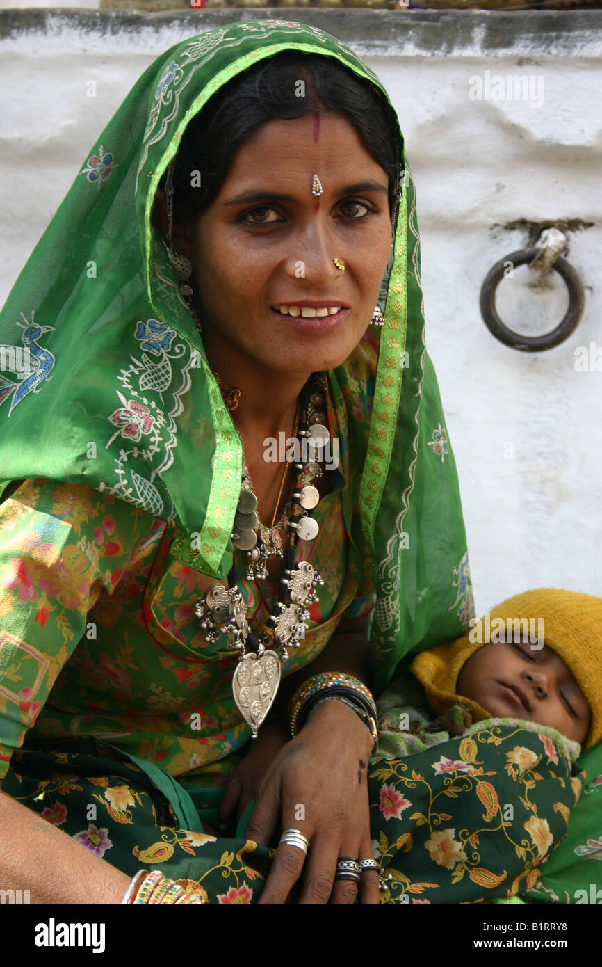 Portrait of a beautiful Rajasthani woman in a decorated green sari ...