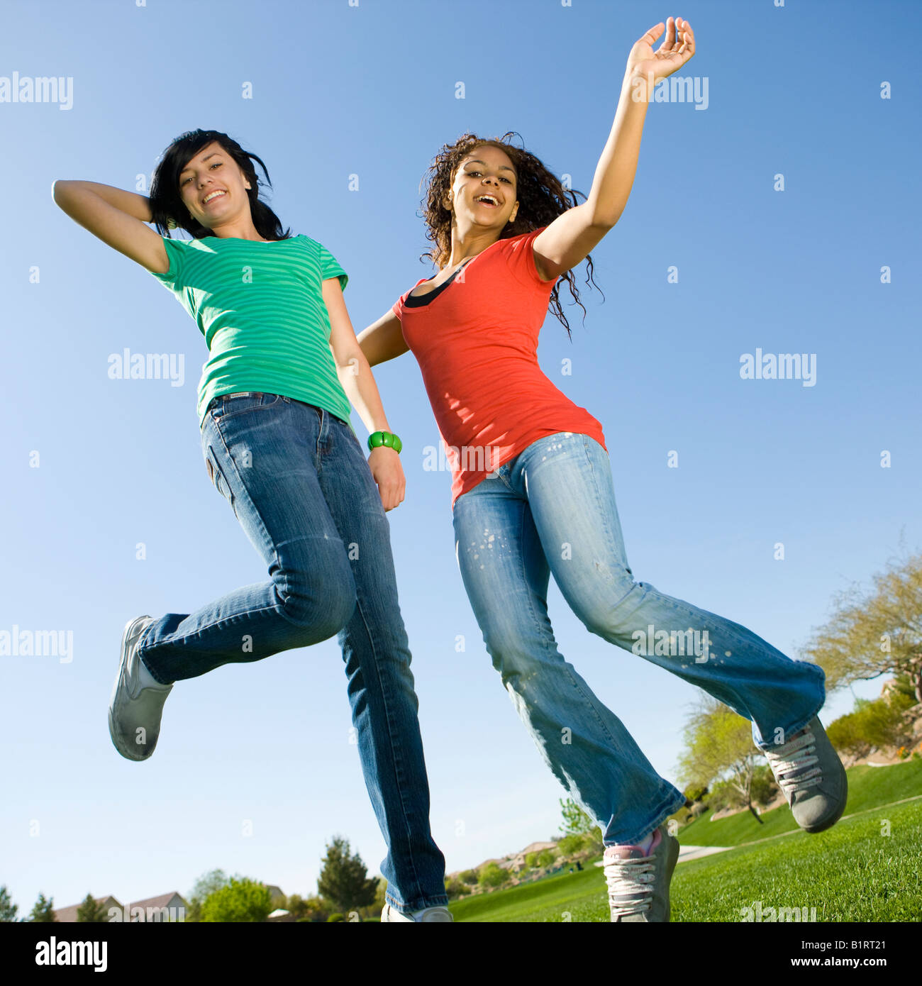 Happy teens jump in air Stock Photo - Alamy
