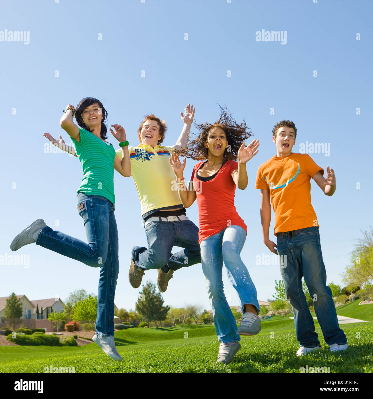 Four happy teens jump in air Stock Photo - Alamy