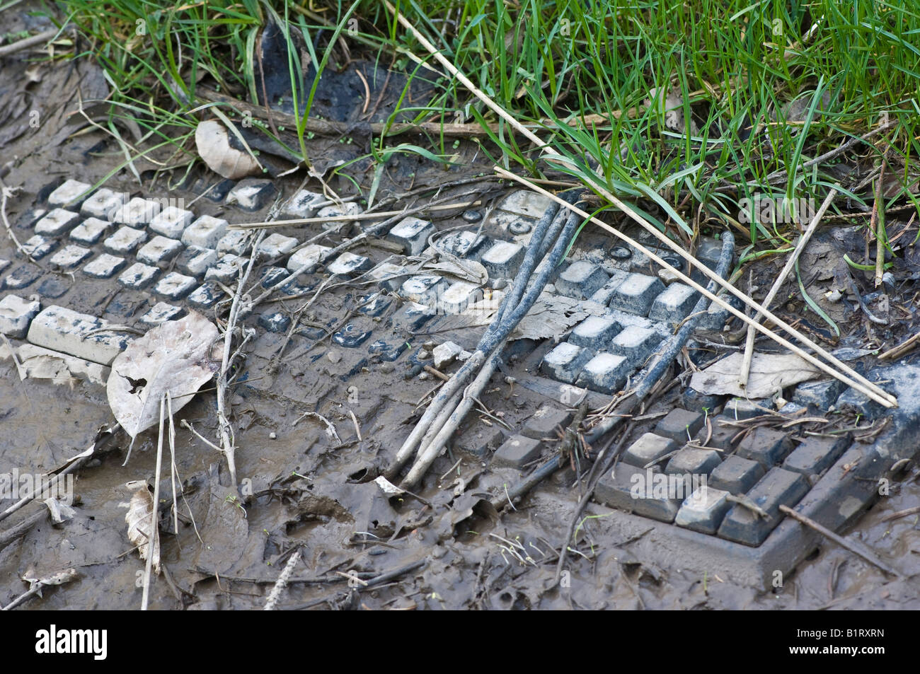 Computer keyboard covered in mud Stock Photo - Alamy