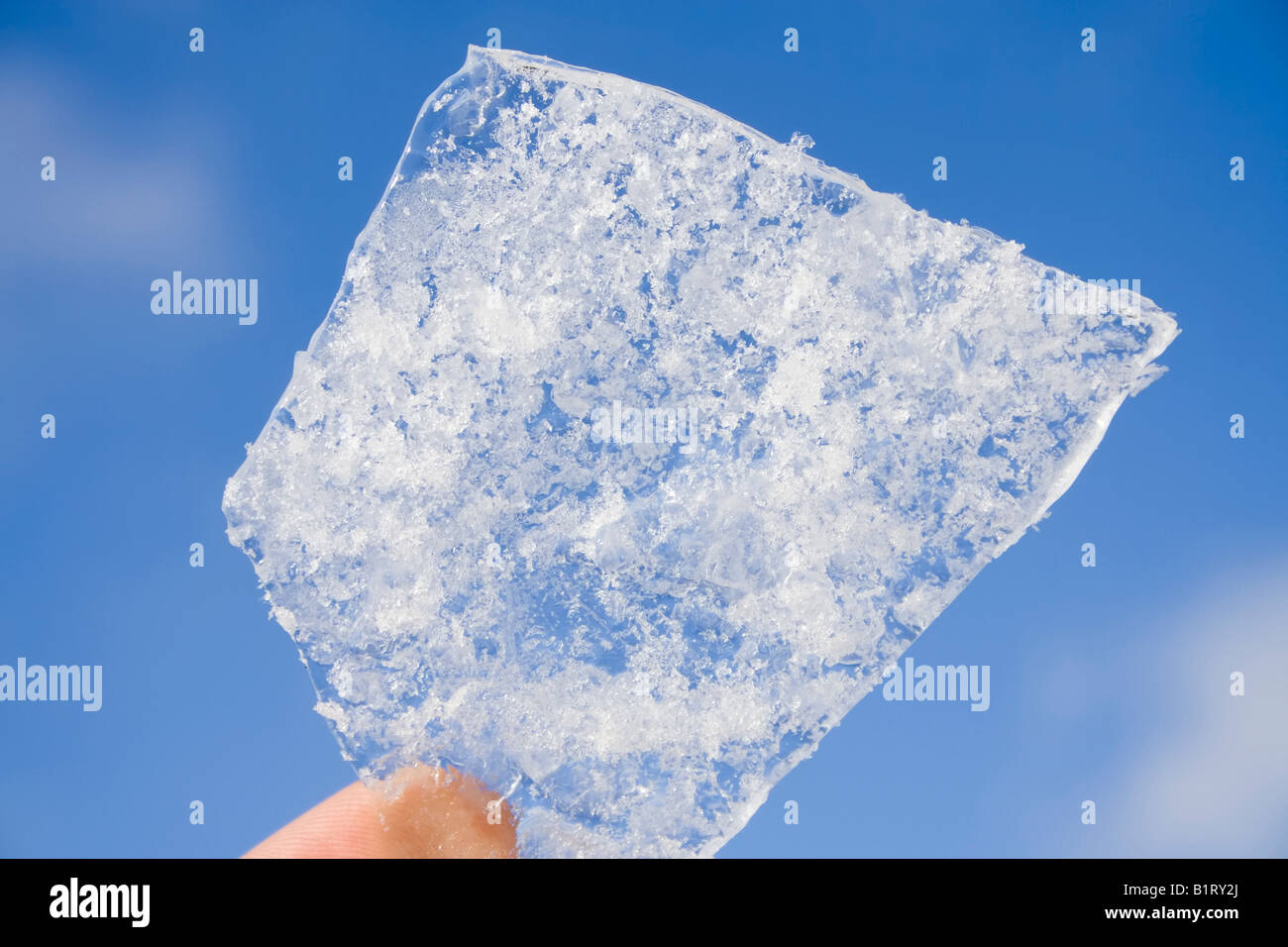 bit of ice in hand on sky background Stock Photo - Alamy