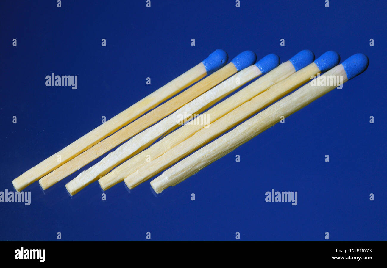 Matches on blue surface Stock Photo - Alamy