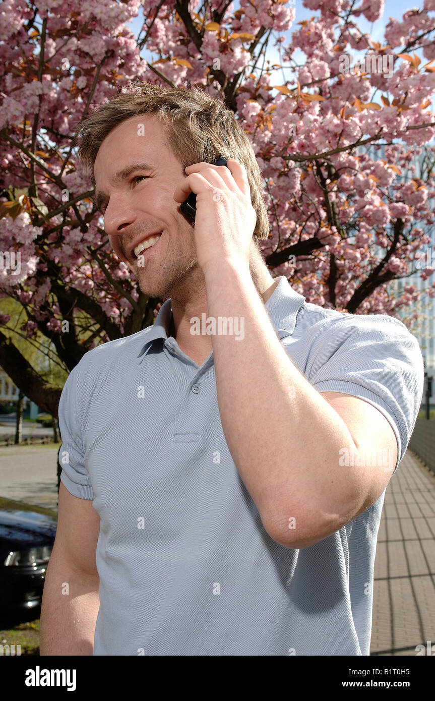 33 year-old man speaking on his cellphone in the city in spring Stock ...