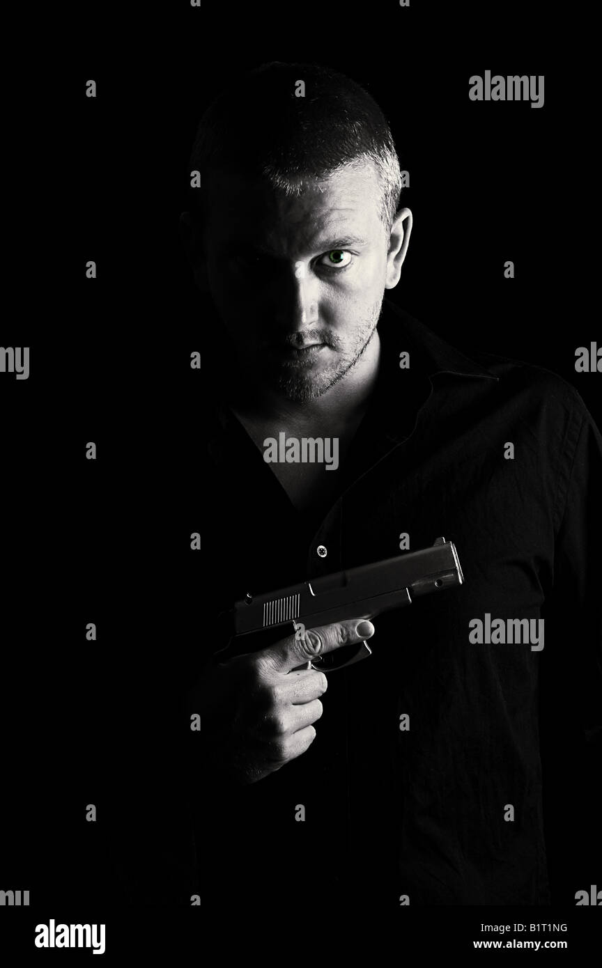 Shot of Menacing Male with Gun to Chest Stock Photo - Alamy