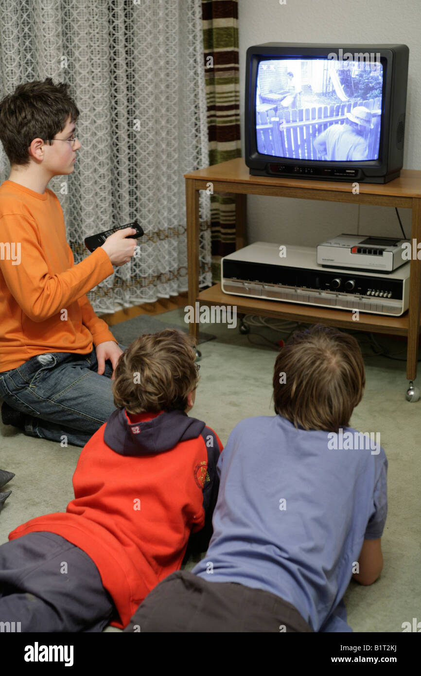 three boys watching television Stock Photo - Alamy