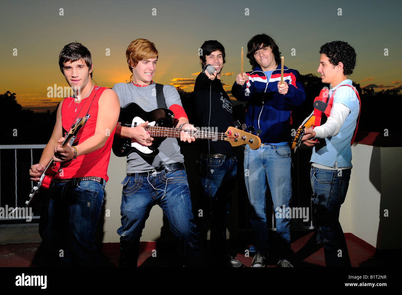 Portrait of trendy group of young musicians having fun with their ...