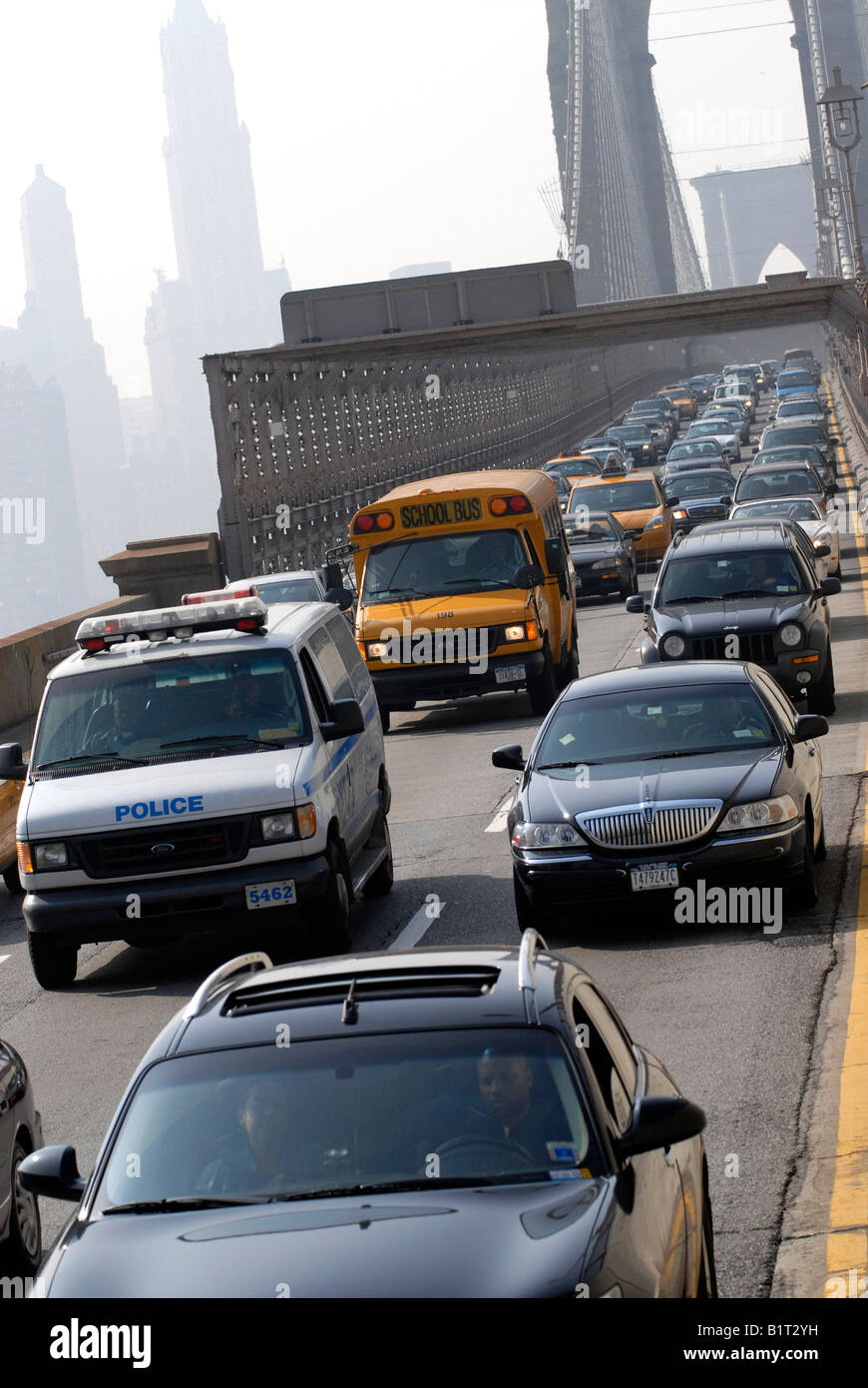 Commuters in their cars and school bus in rush hour traffic jam on the ...