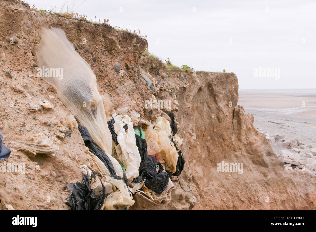 old landfill rubbish revealed in sea cliffs by coastal erosion on ...