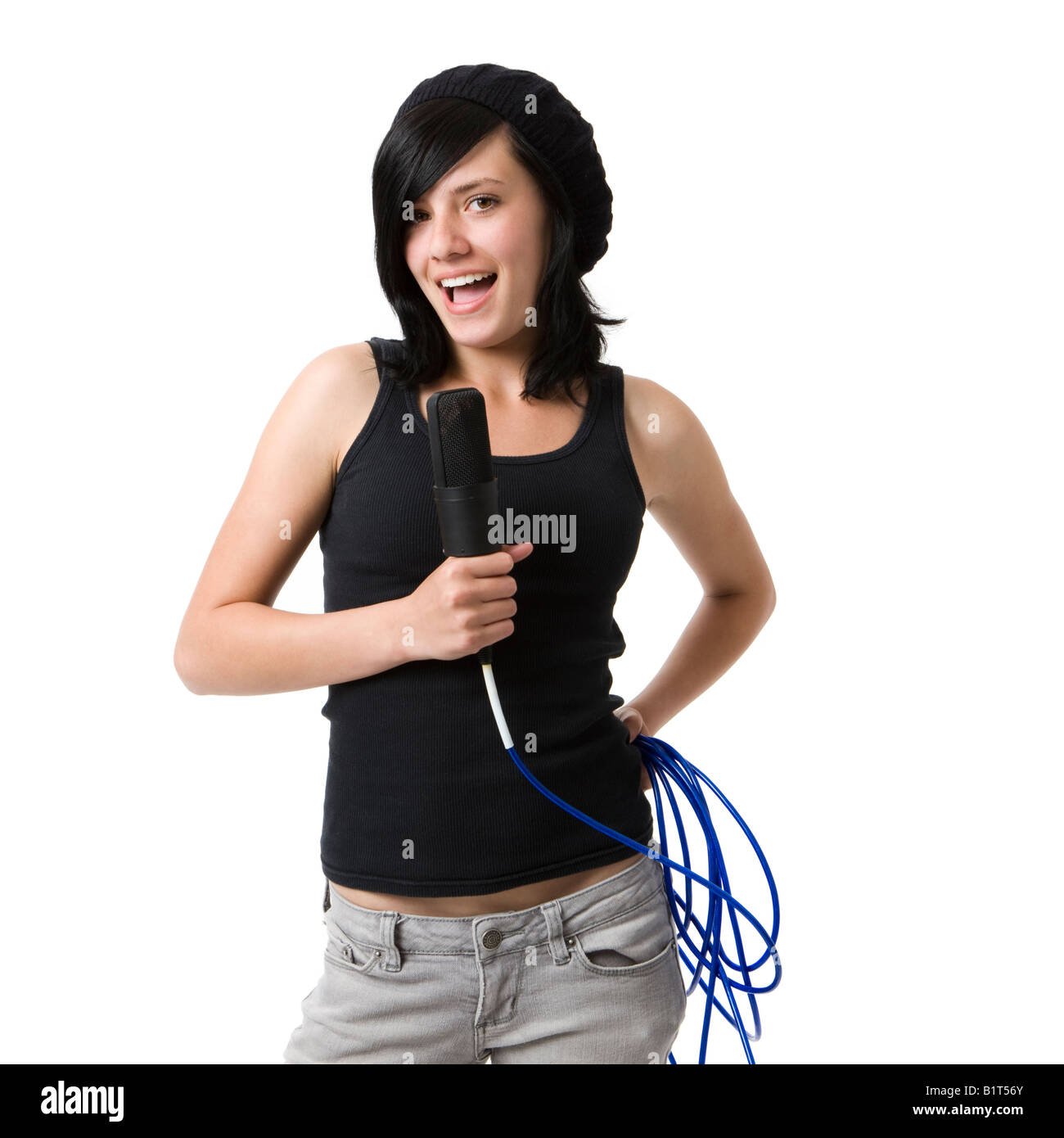 A girl sings into a mic Stock Photo - Alamy