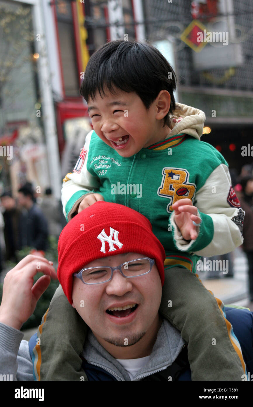 Japanese Child Smiling on his fathers shoulders in China Town in port ...