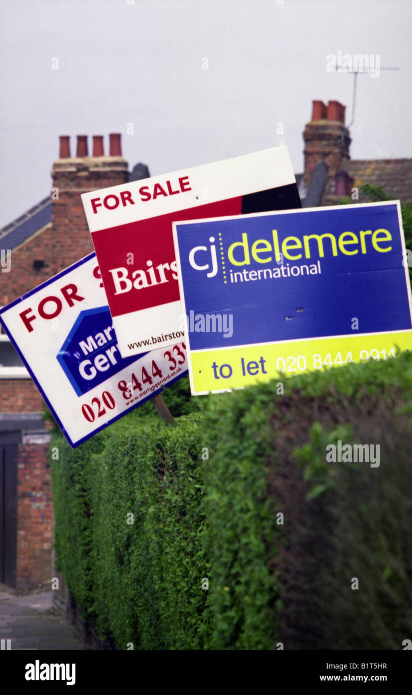 Cluster of 'For Sale' and 'To Let' signs outside of property Stock ...