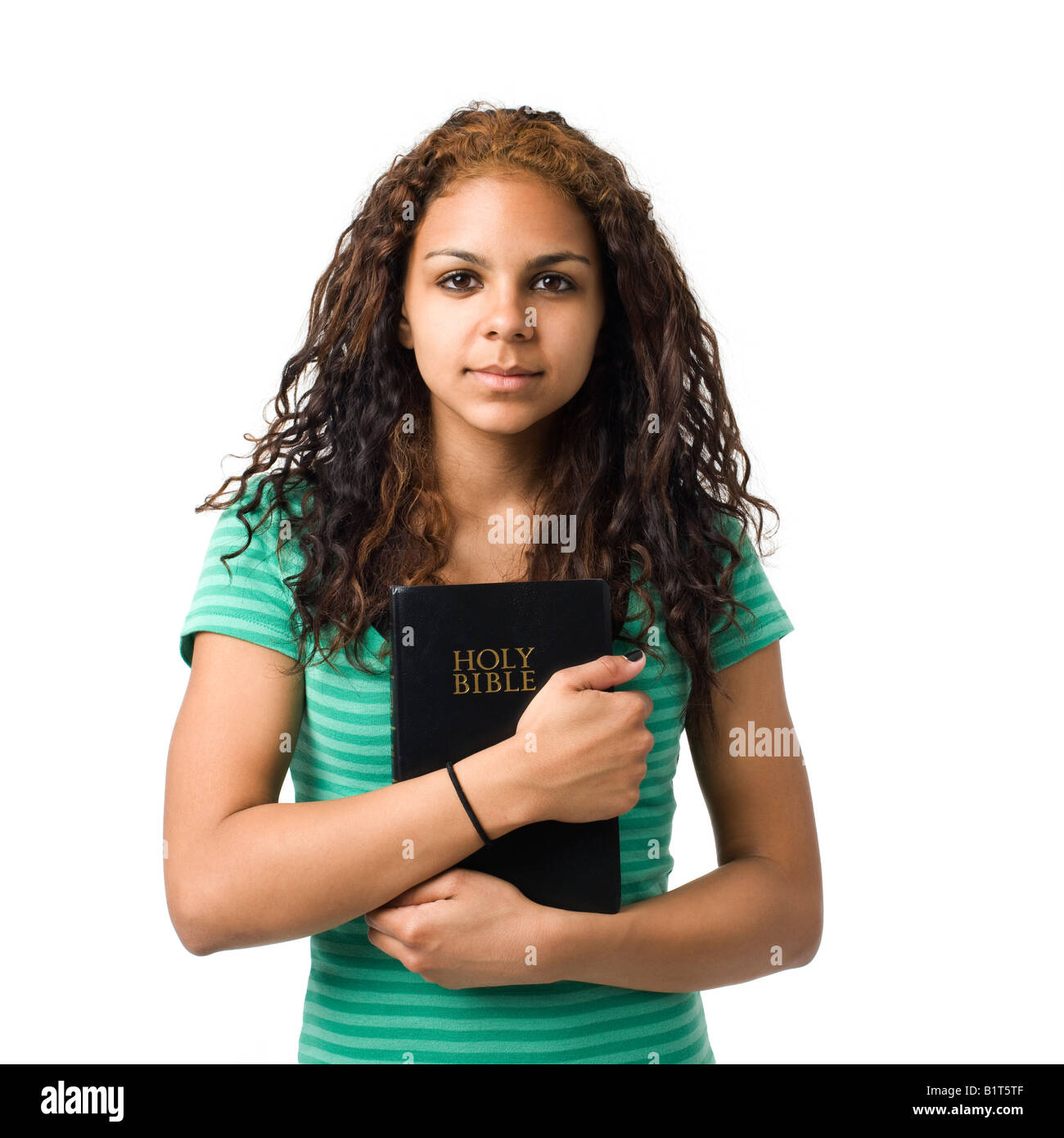 Teen girl holds bible in her hands Stock Photo - Alamy
