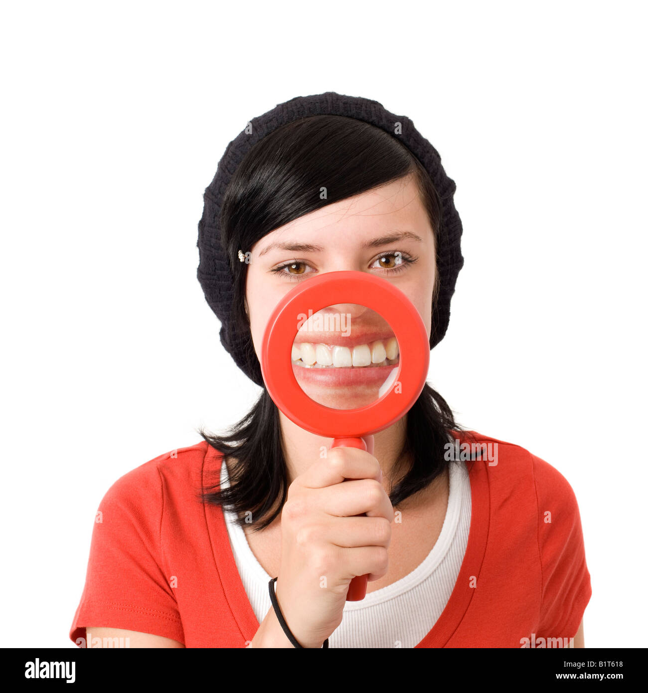 Girl shows teeth with magnifying glass Stock Photo - Alamy