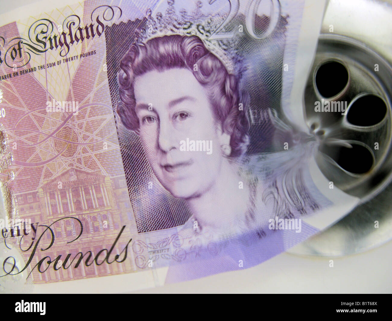 twenty pond note in bath going down the plug hole Stock Photo - Alamy