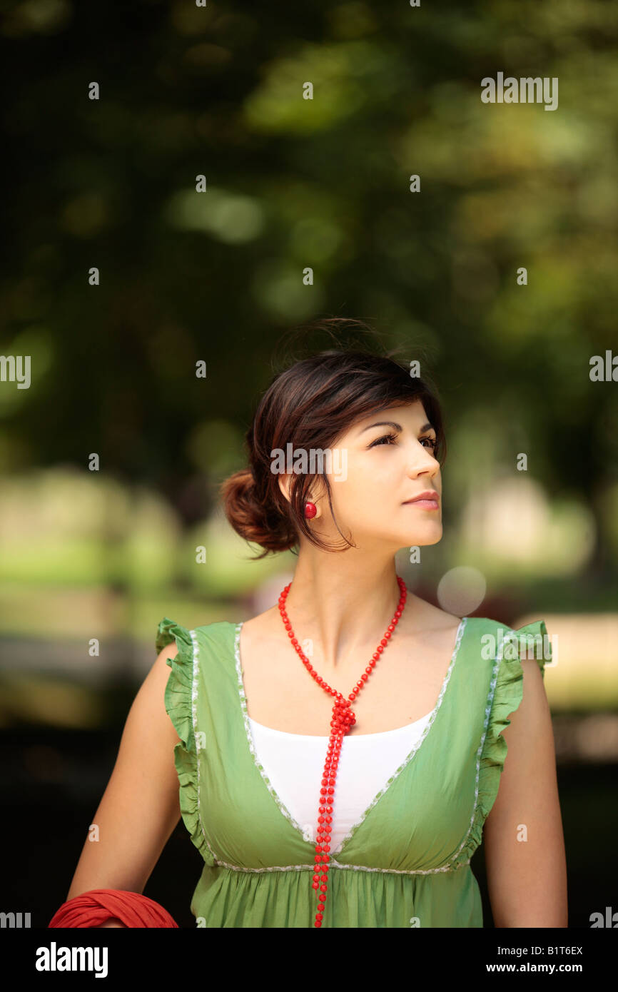 young lady outdoor looking at the nature around her with a peaceful ...