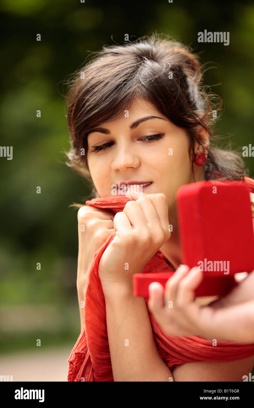 Young beautiful lady looking at the someone who is holding in front of ...