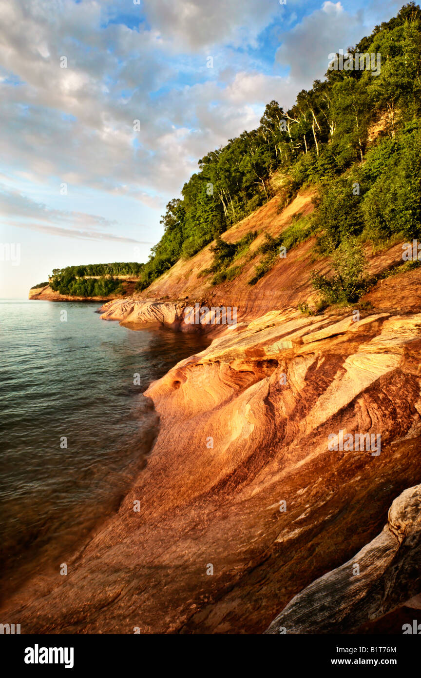 When the sun sets over Lake Superior the sandstone of Pictured Rocks ...