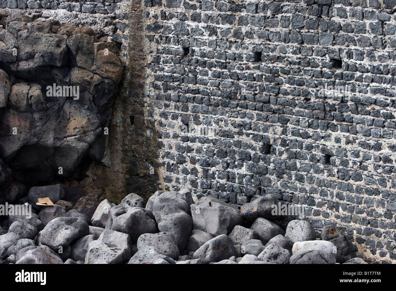Quarried stone blocks a brick retaining wall in Catania, Sicily, Italy ...