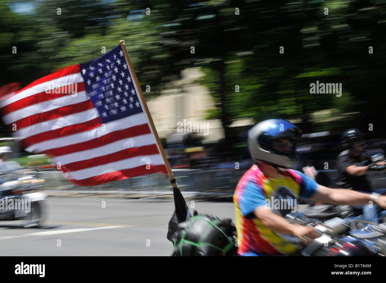 A motorcycle with the American flag in the rally during Rolling Thunder ...