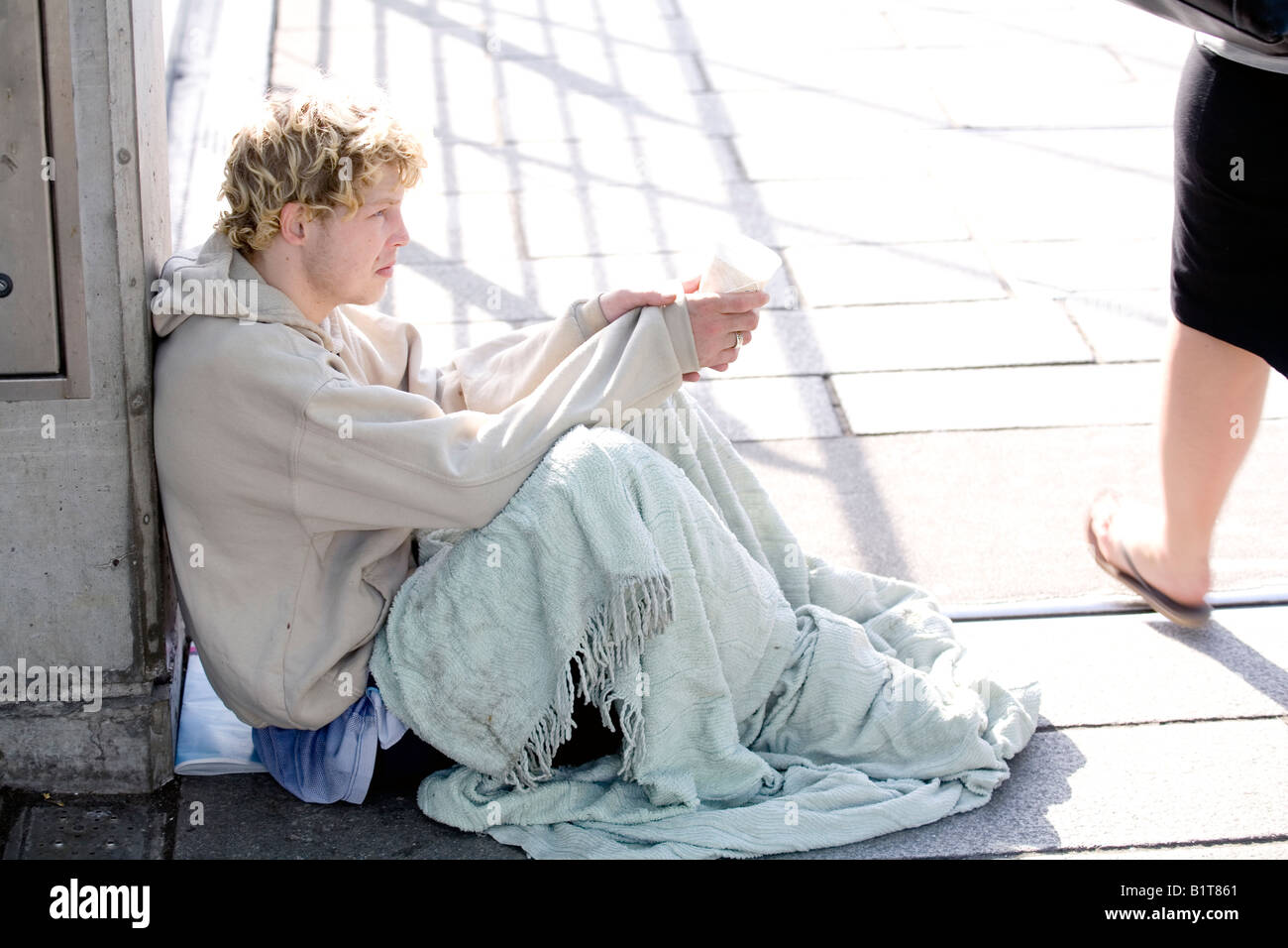 Young homeless man sitting on the floor , London, England, Britain, UK ...