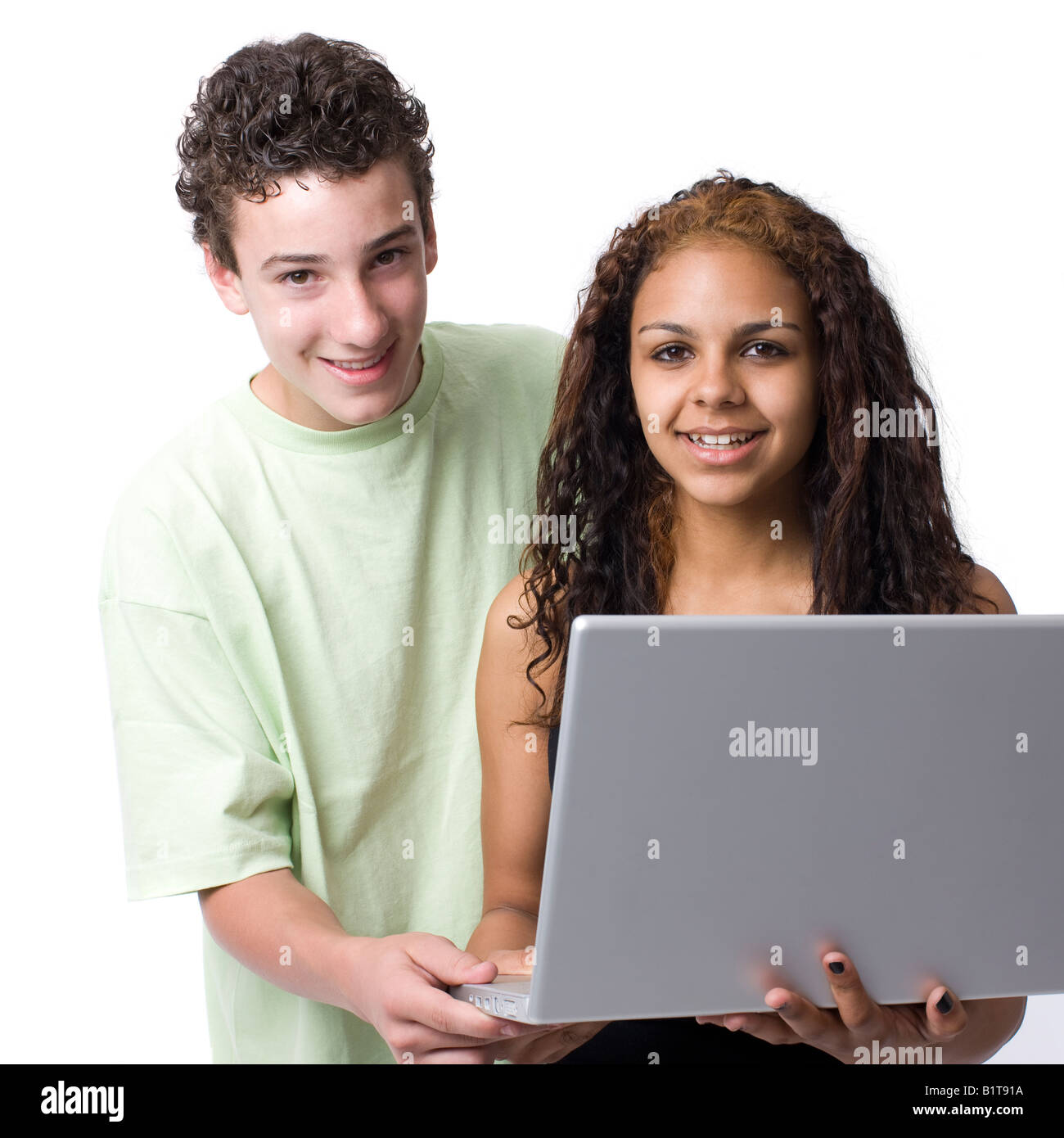 Two teens share a laptop Stock Photo - Alamy